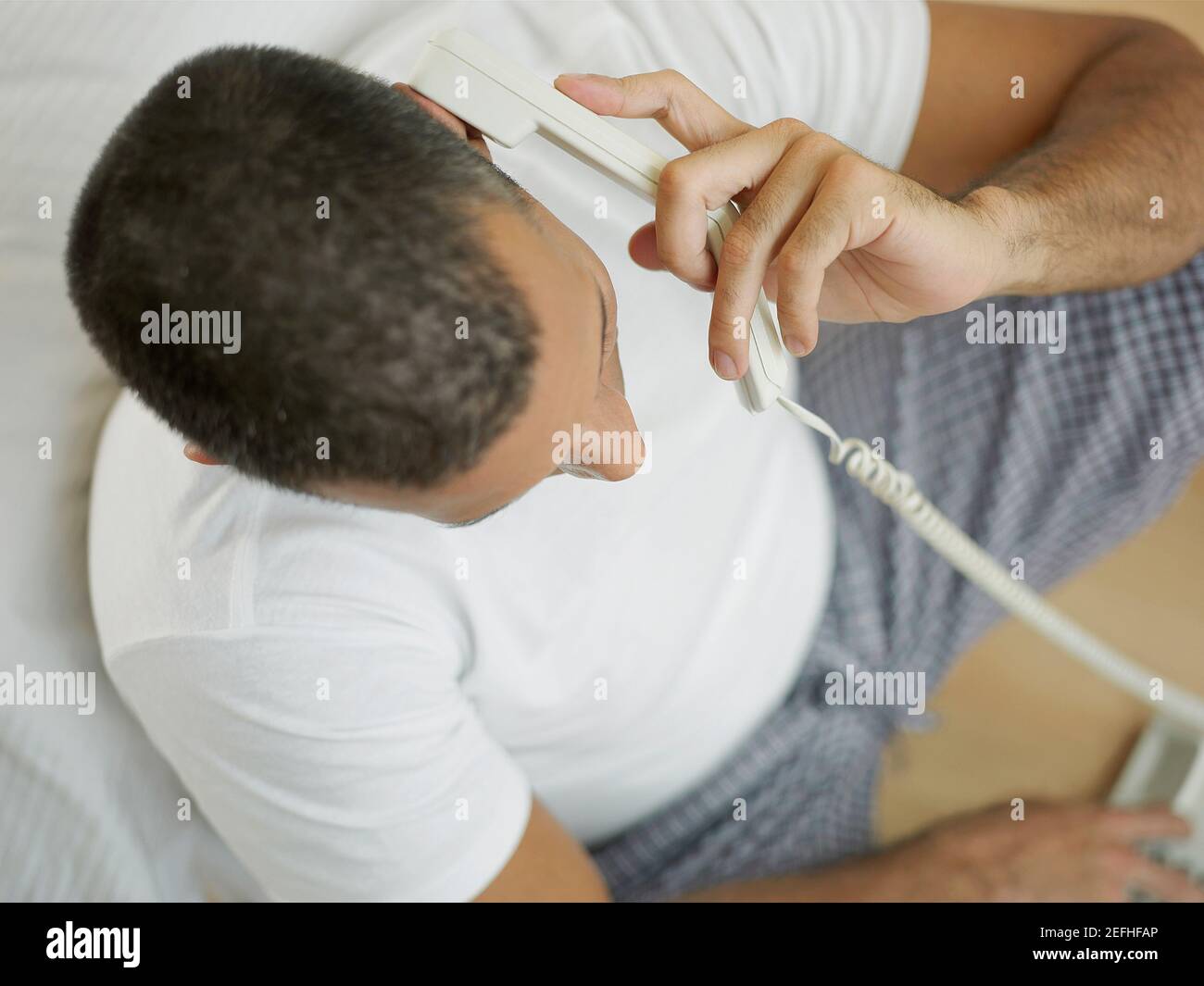 High angle view of a mid adult man talking on the telephone Stock Photo ...