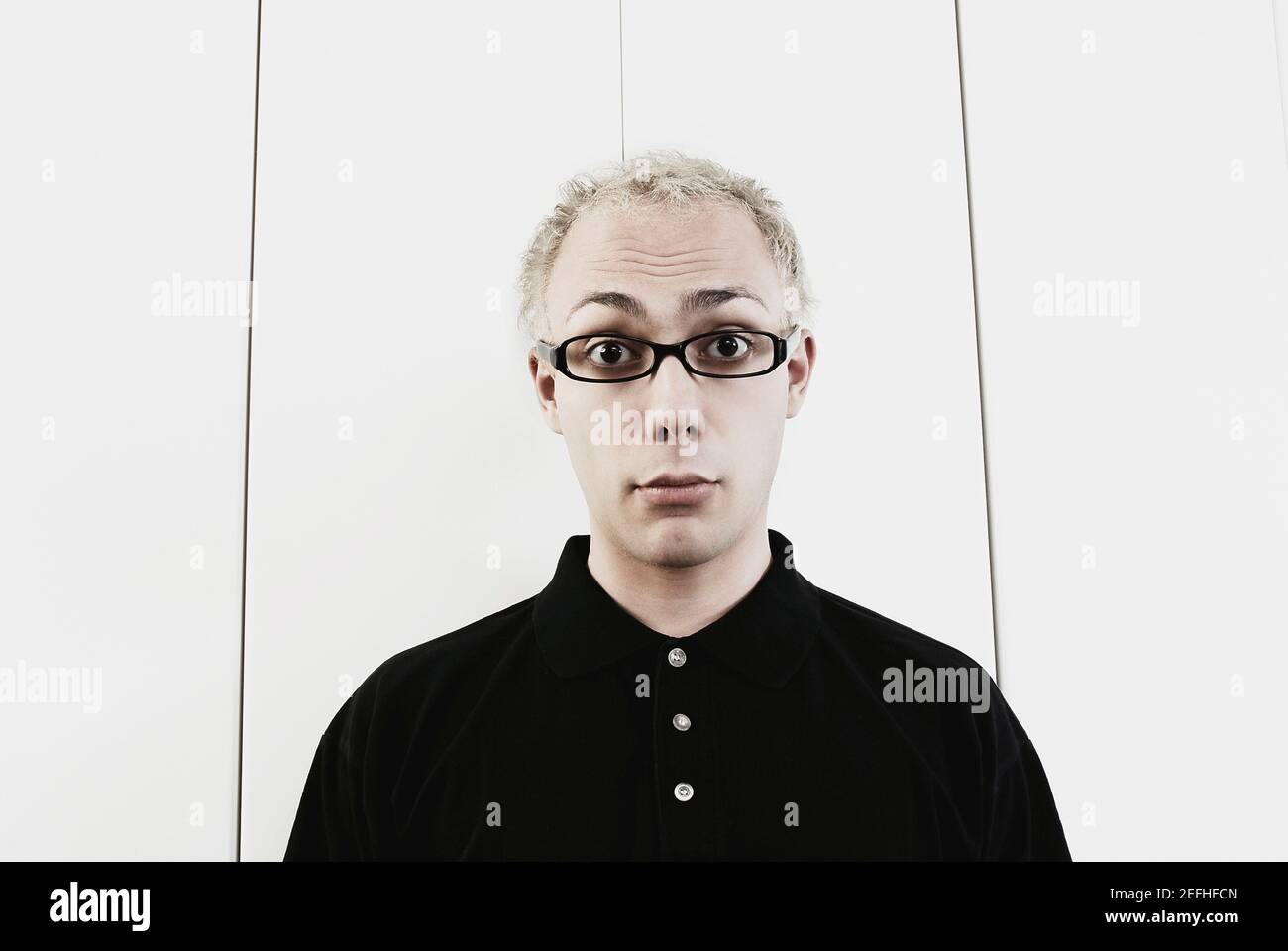 Portrait of a young man looking displeased Stock Photo - Alamy