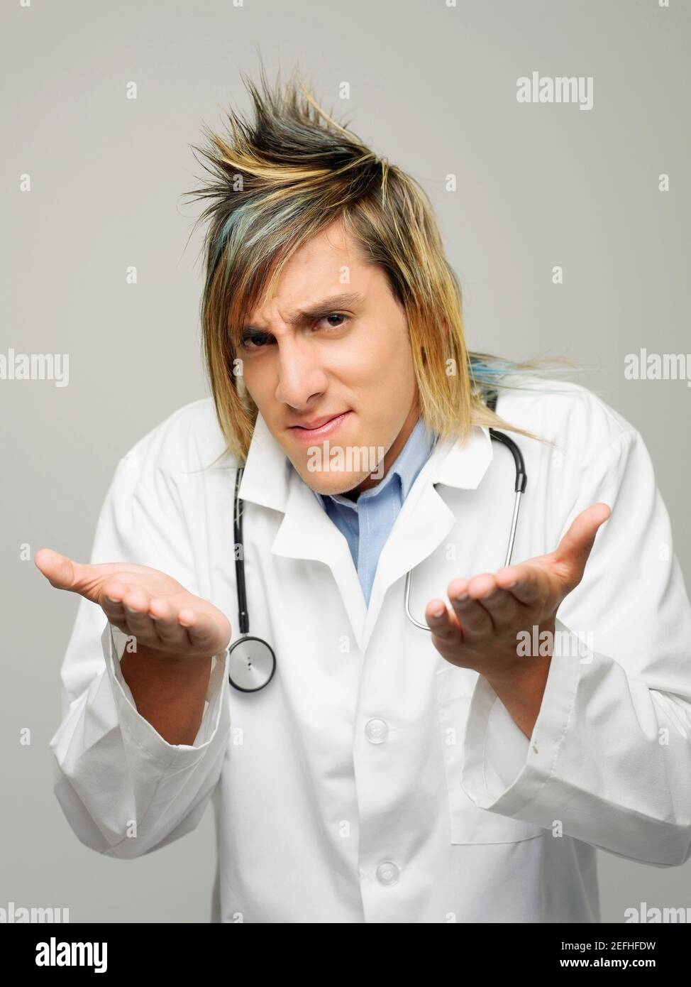 Portrait of a male doctor shrugging Stock Photo - Alamy