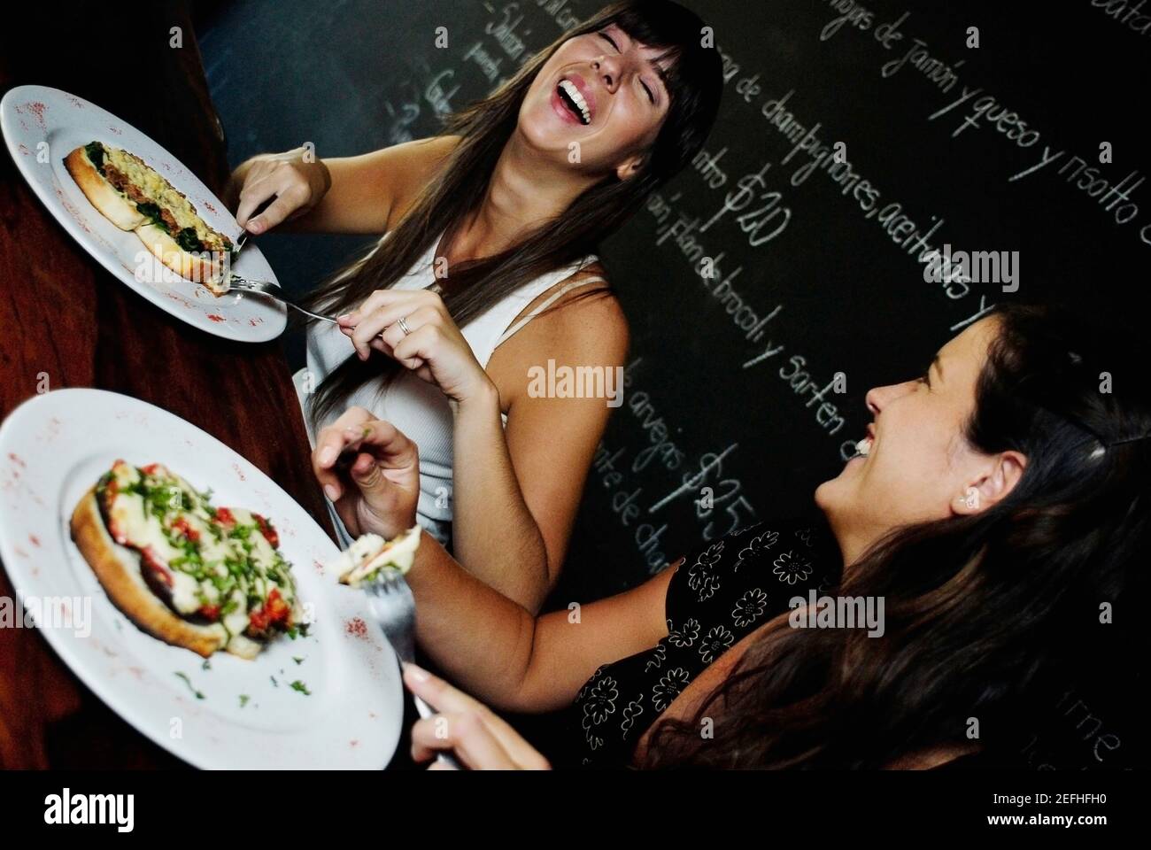 Young women eating restaurant interior hi-res stock photography and ...