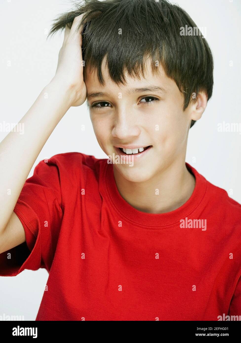 Portrait of a boy with his hand in his hair Stock Photo - Alamy