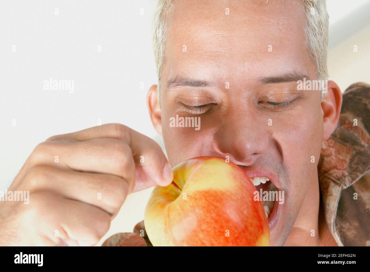 Man biting apple hi-res stock photography and images - Alamy