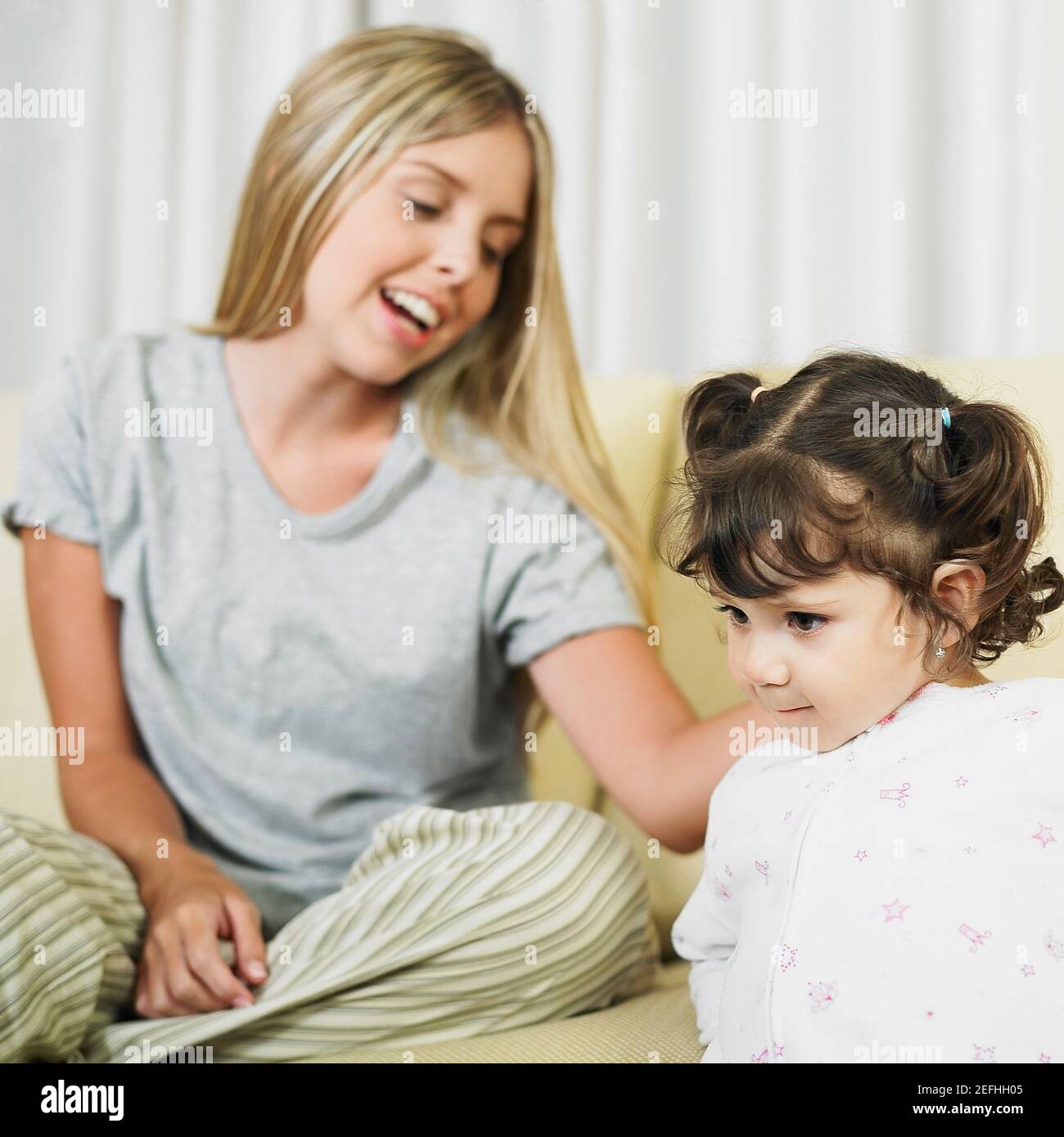 Young woman touching her daughter Stock Photo - Alamy