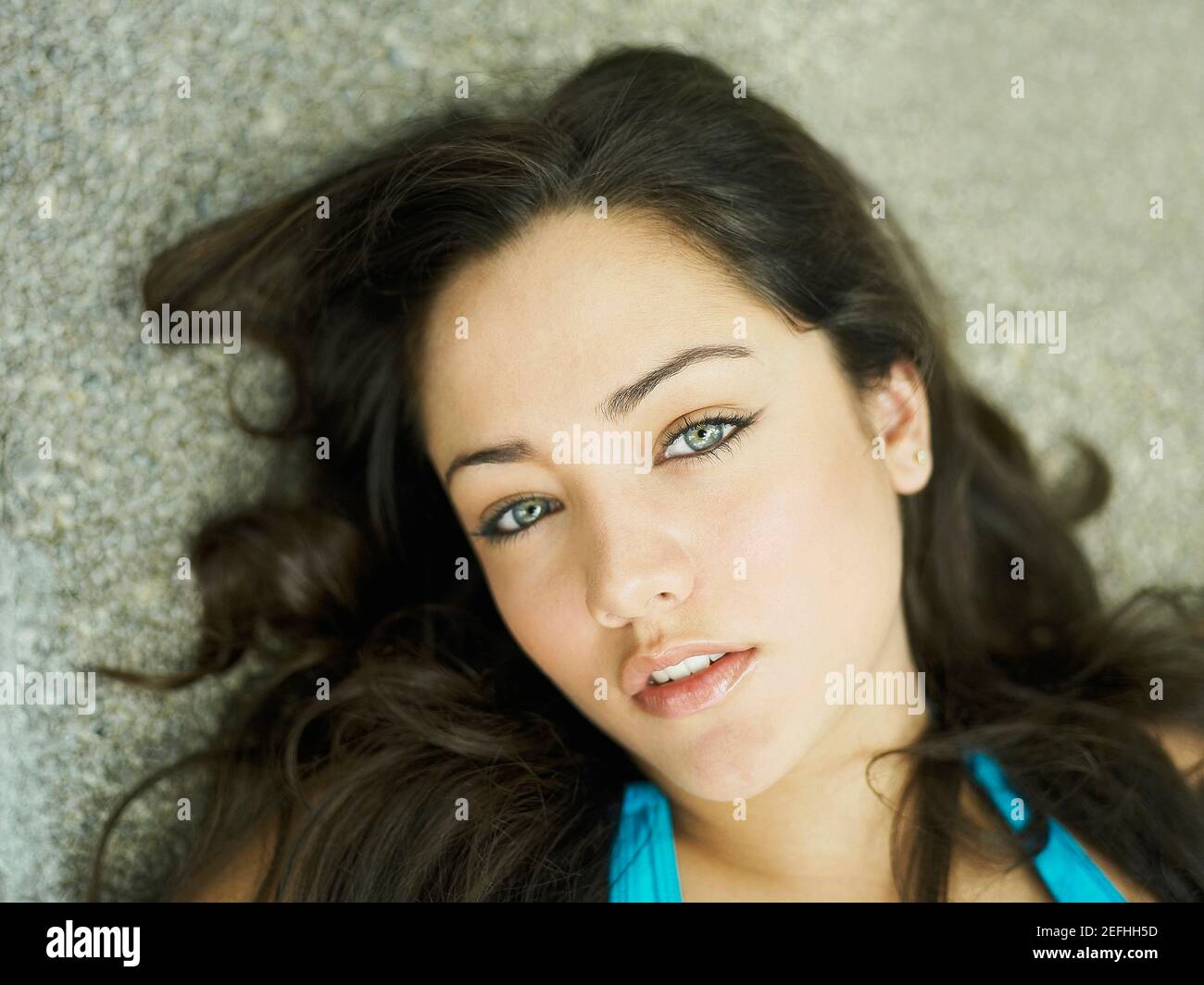 Portrait of a young woman lying on her back Stock Photo - Alamy