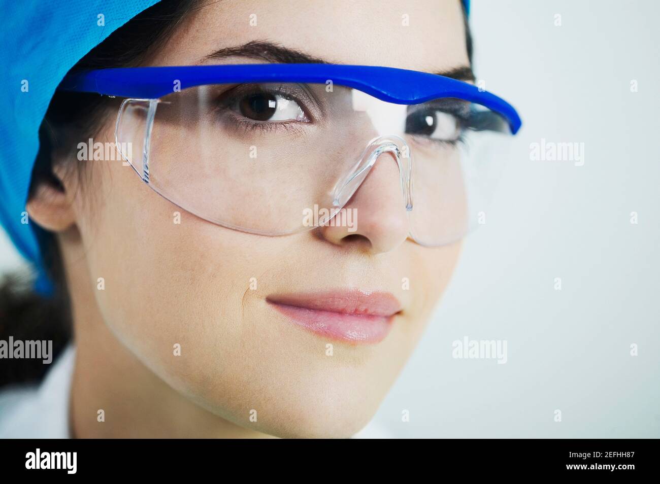 Portrait of a female doctor wearing a surgical cap and protective ...