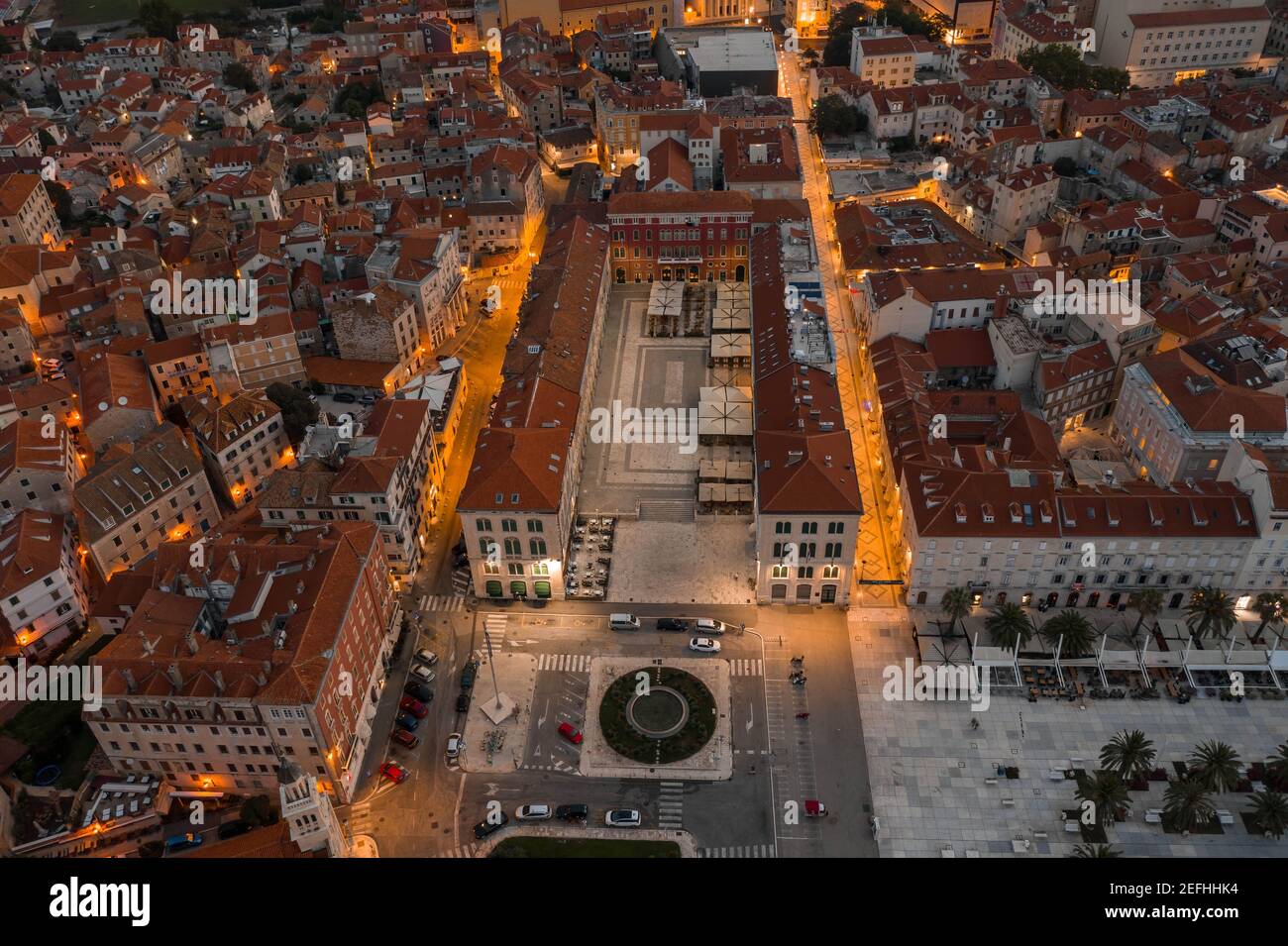 Aerial drone shot of empty republic square by riva with light at dusk ...
