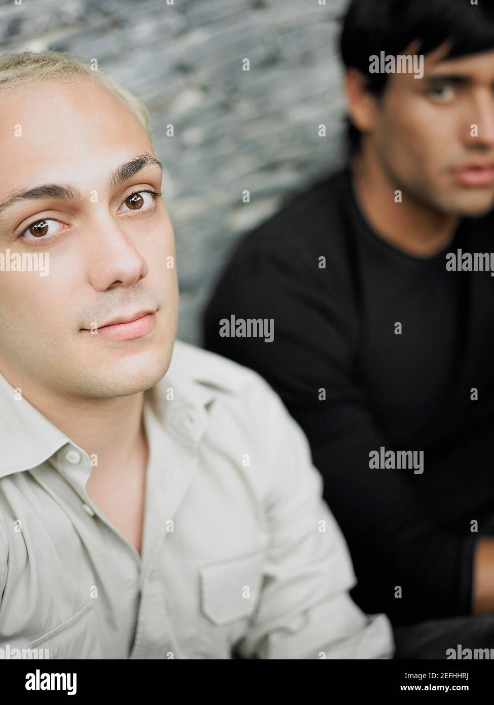 Portrait of two young men sitting together Stock Photo - Alamy