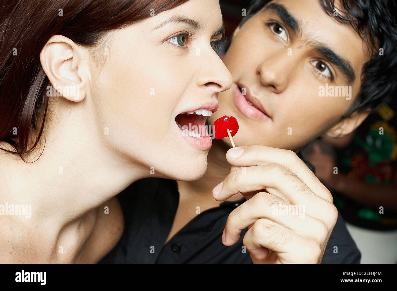 Couple woman feeding man cherry hi-res stock photography and images - Alamy