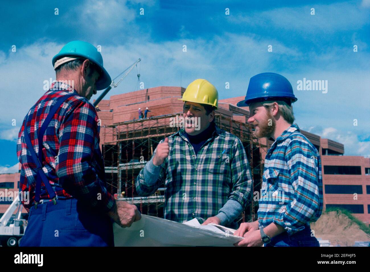 Construction crew looking at blueprints Stock Photo - Alamy