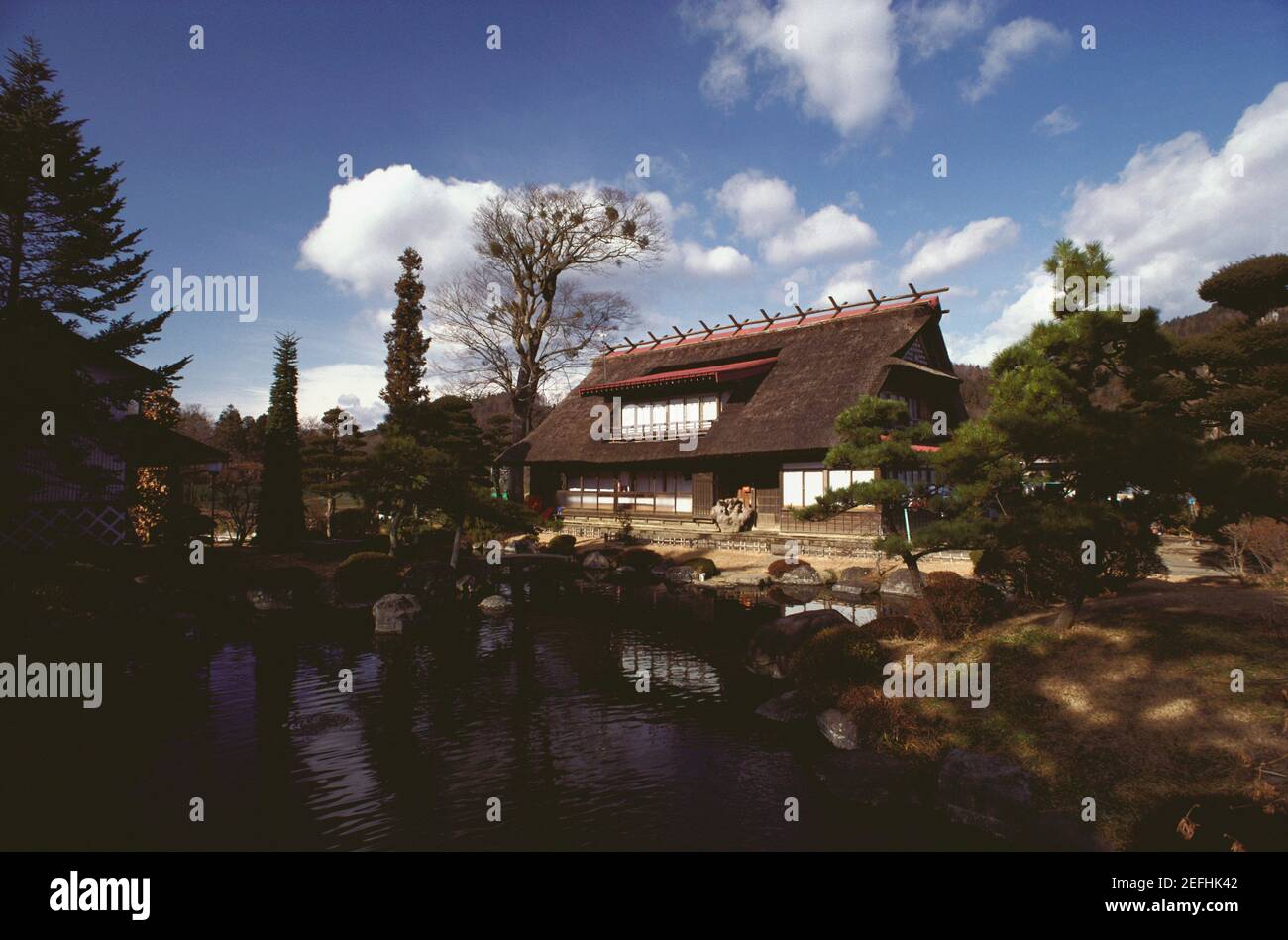 Thatched farm house in front of a lake, Hakone, Kanagawa Prefecture ...