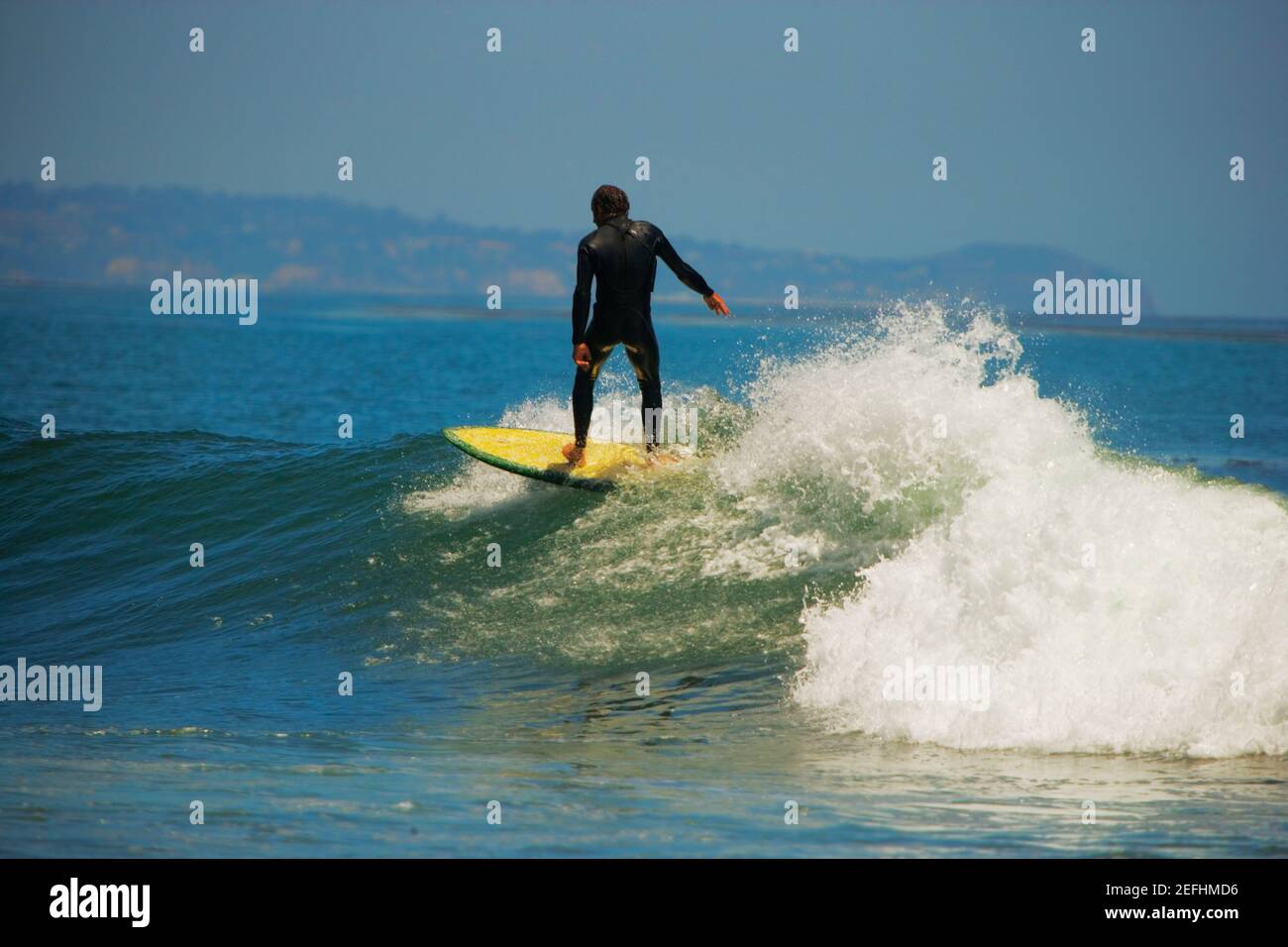 Rear view of a person surfing Stock Photo - Alamy