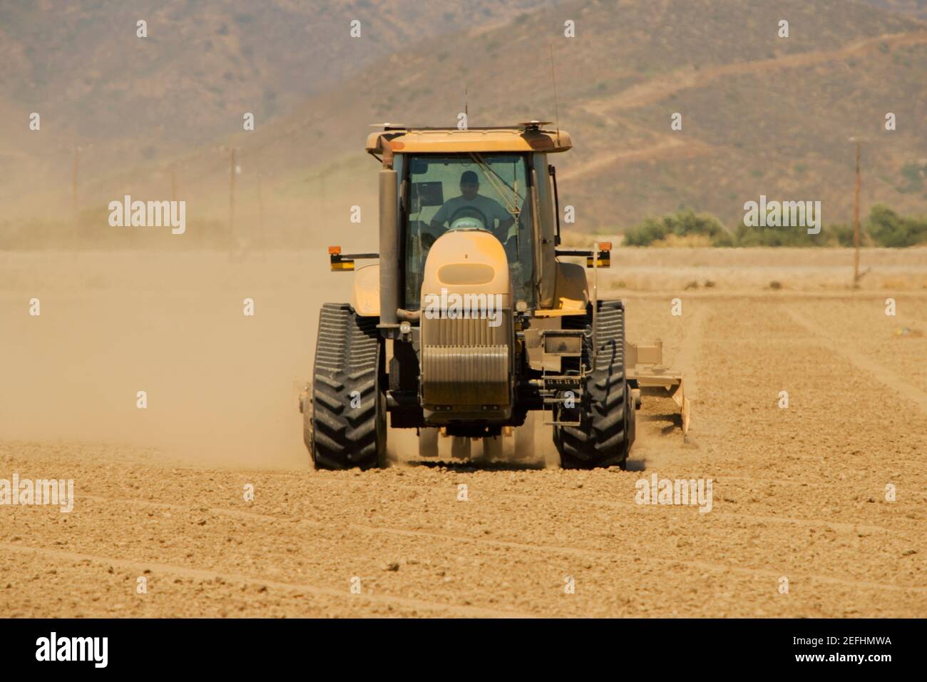 Front profile of a tractor in a field Stock Photo - Alamy