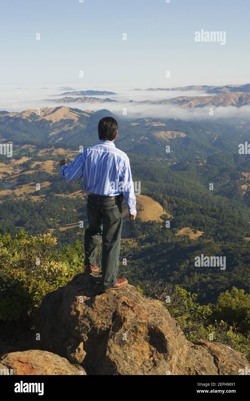 High angle view of a man standing on a hilltop Stock Photo - Alamy