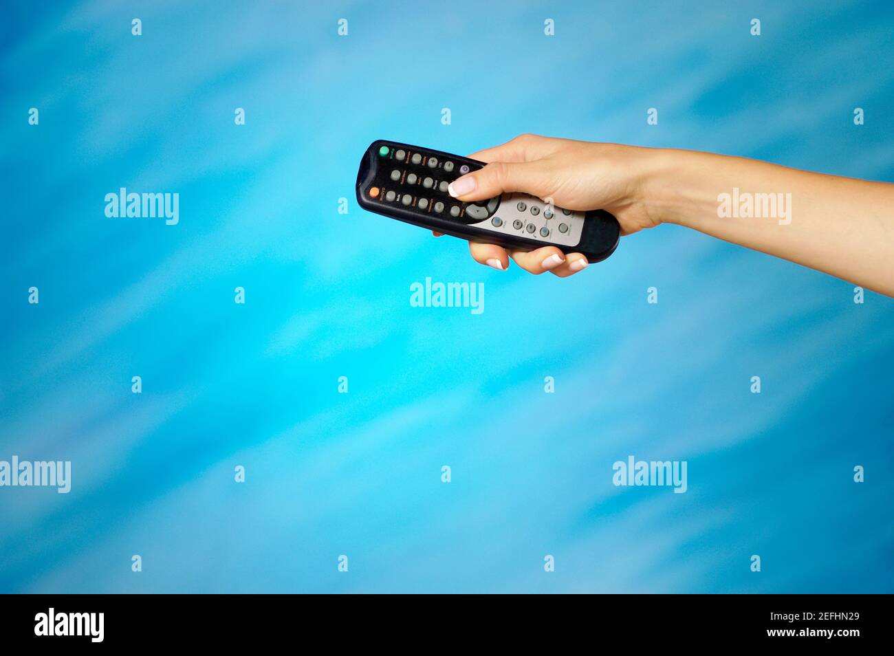 Woman pressing remote control hi-res stock photography and images - Alamy
