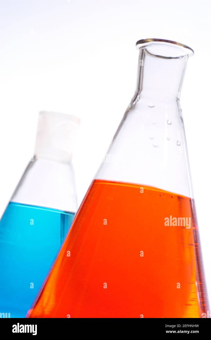 Close-up of two beakers containing chemicals Stock Photo - Alamy