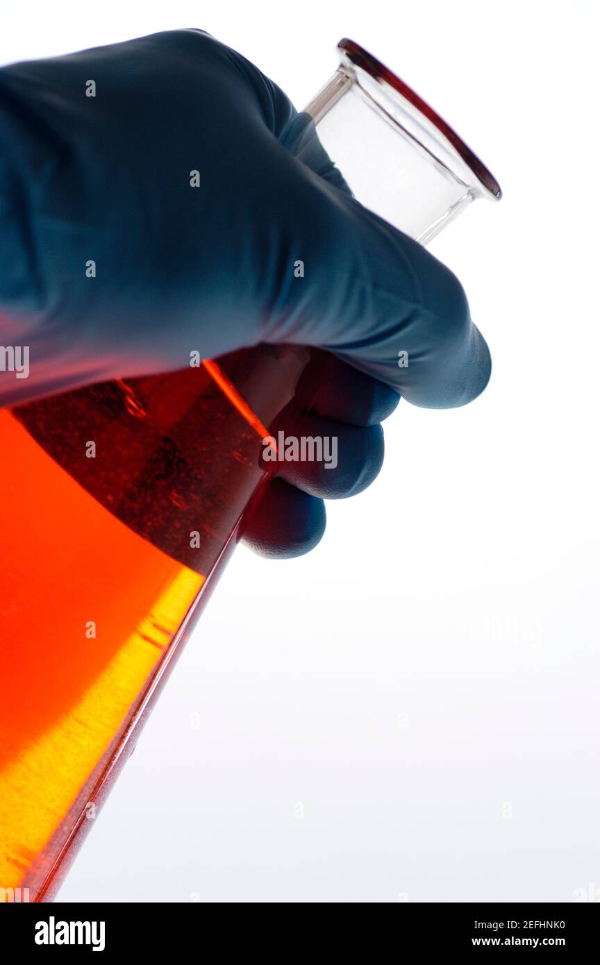 Close up of a person holding a beaker hi-res stock photography and ...