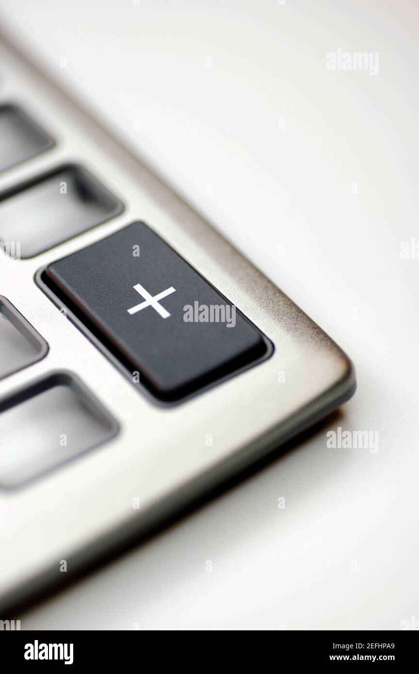 Close-up of an addition button on a calculator Stock Photo - Alamy