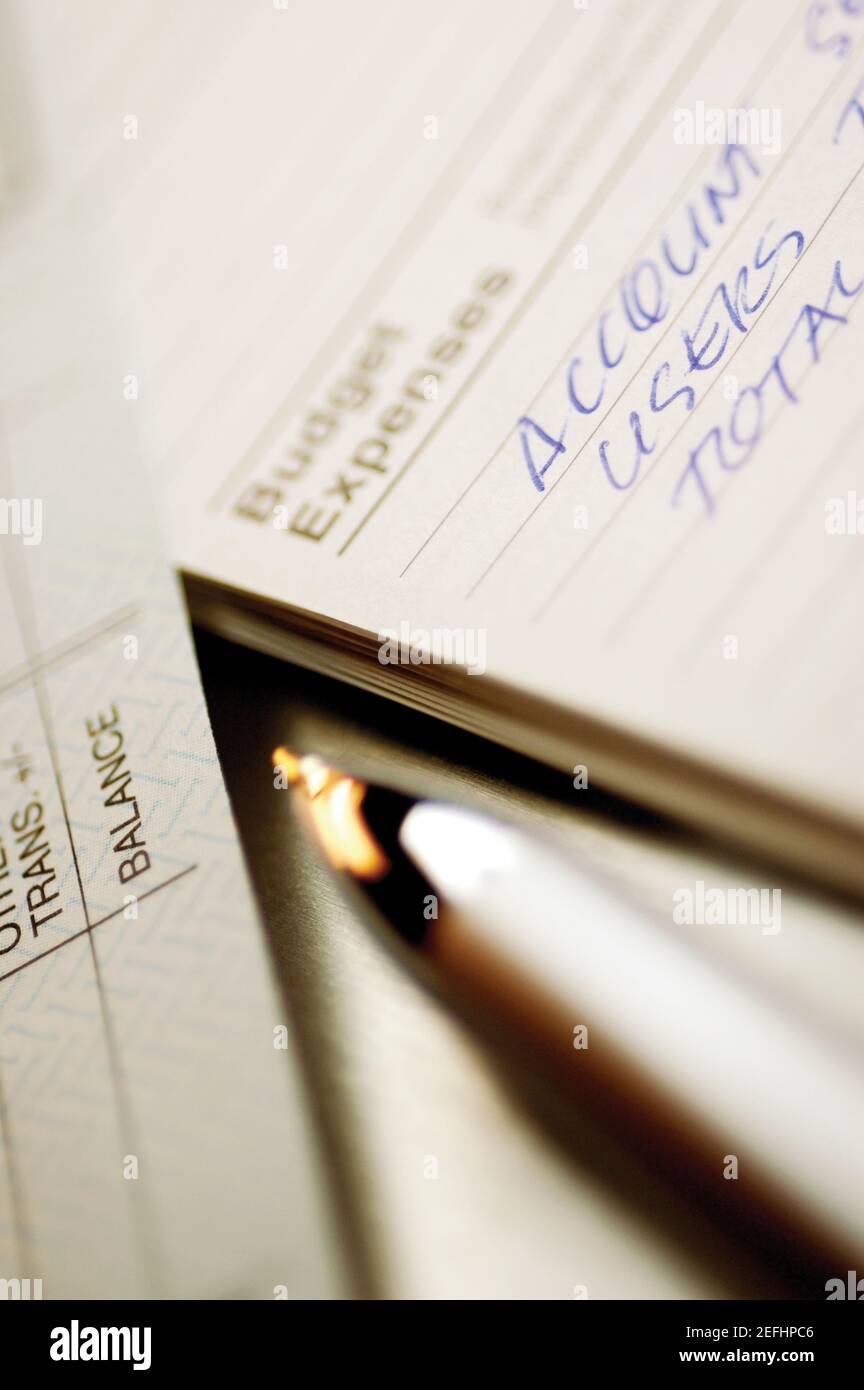 Close-up of a pen with a bank deposit slip and a personal organizer ...