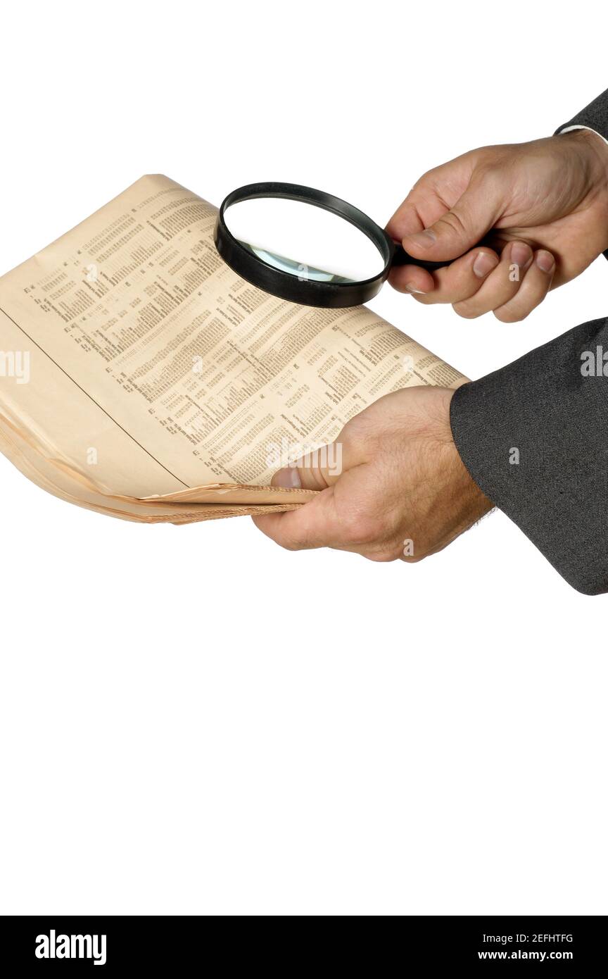 Reading newspaper magnifying glass hi-res stock photography and images ...