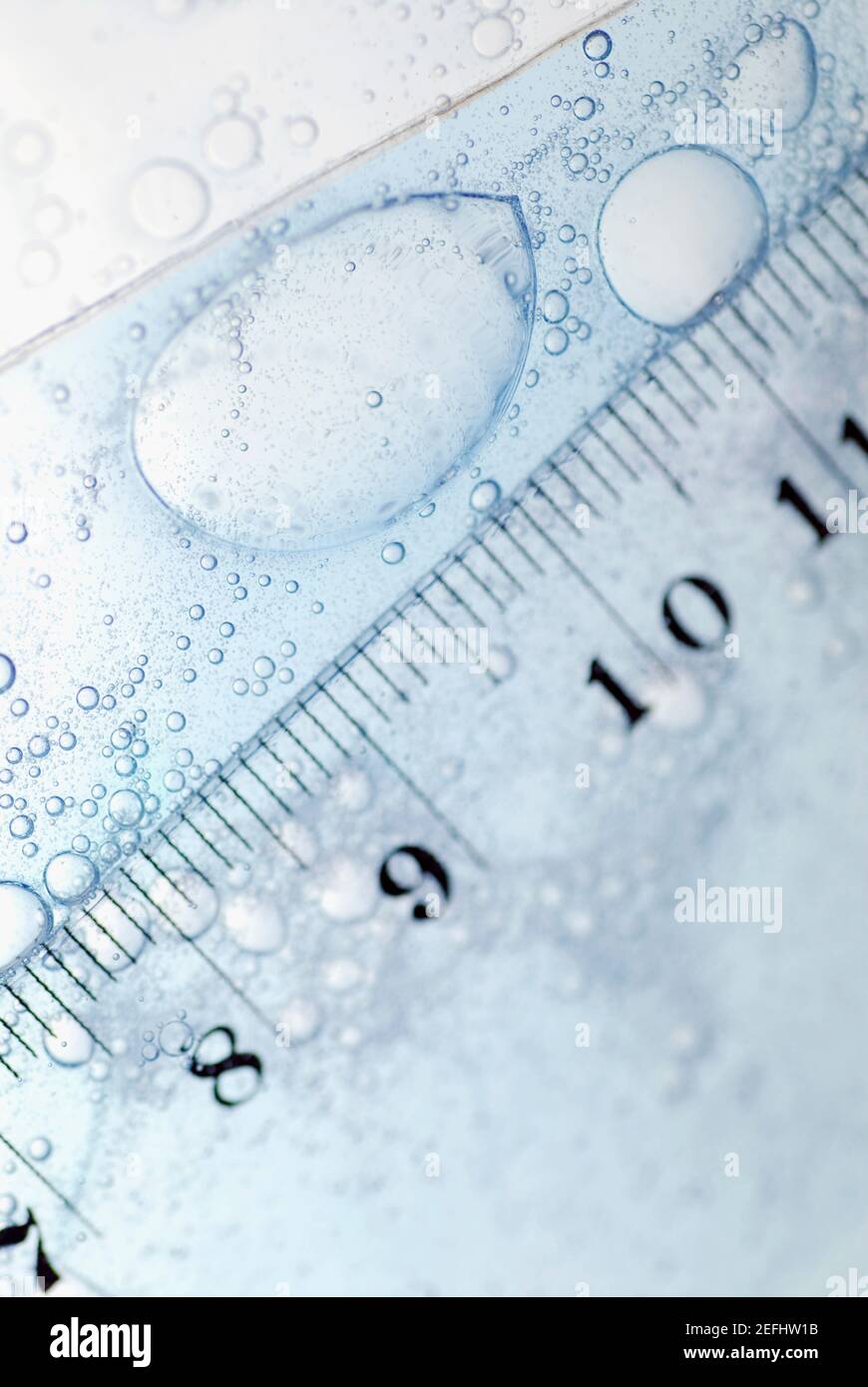 Close-up of a ruler in water Stock Photo - Alamy