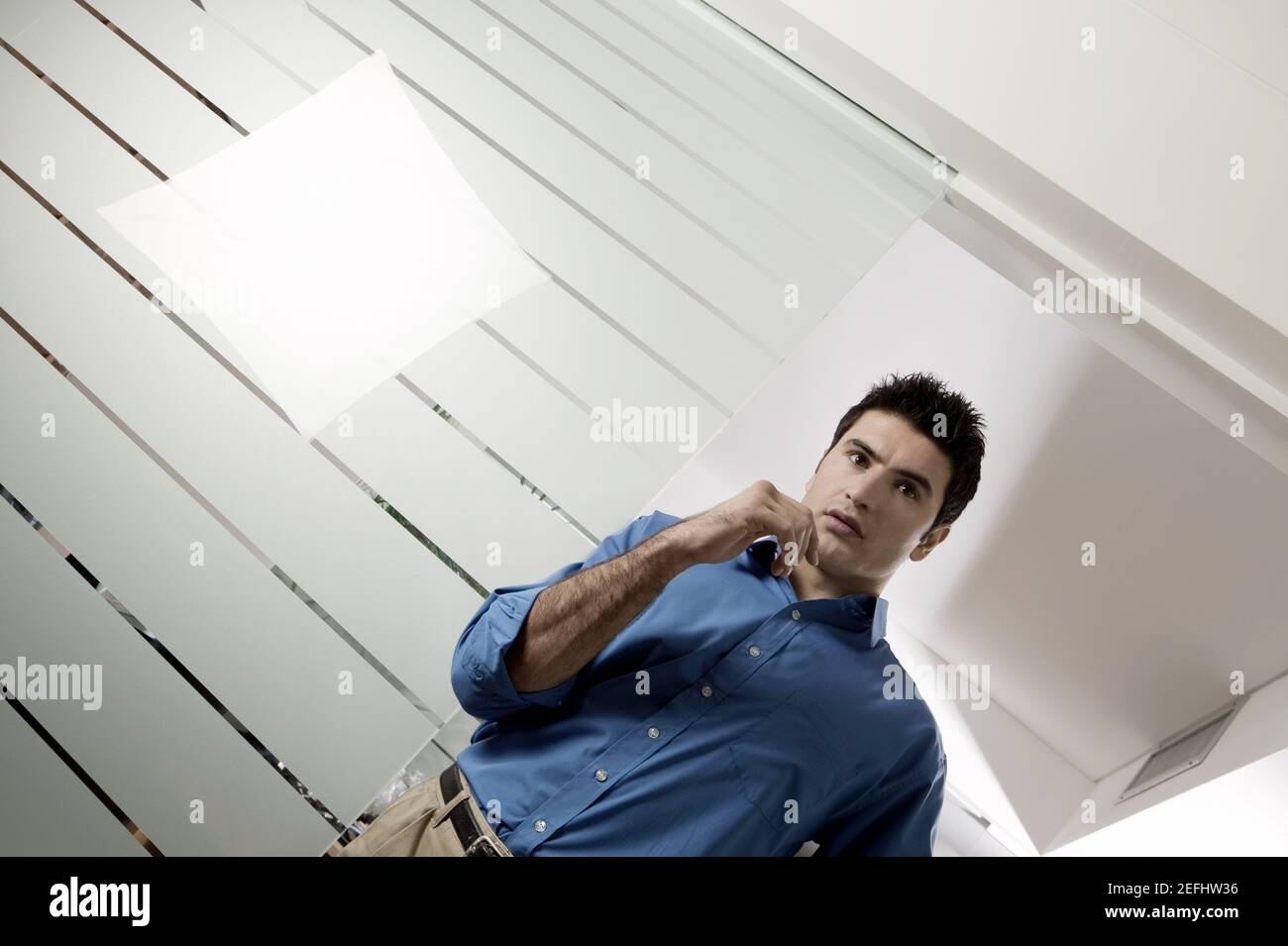 Low angle view of a businessman thinking Stock Photo - Alamy