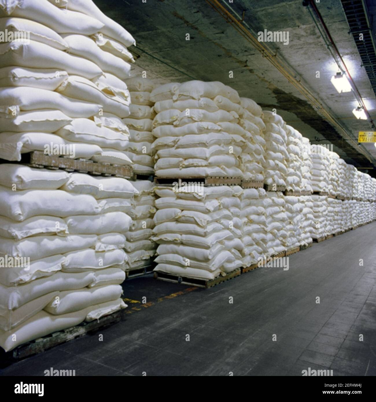 Sacks stacked in a warehouse Stock Photo - Alamy