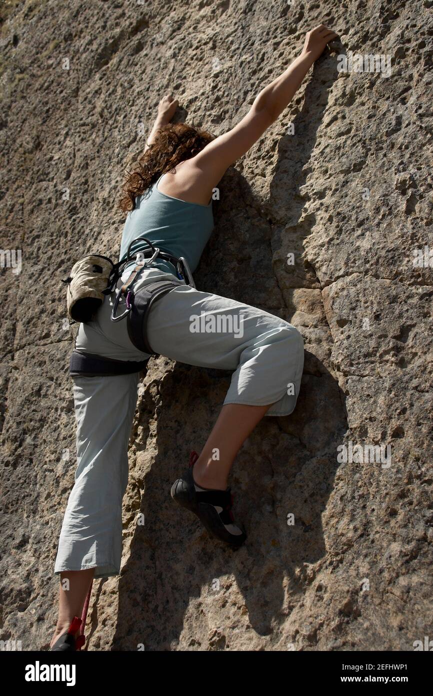 Female rock climber scaling a rock face Stock Photo - Alamy