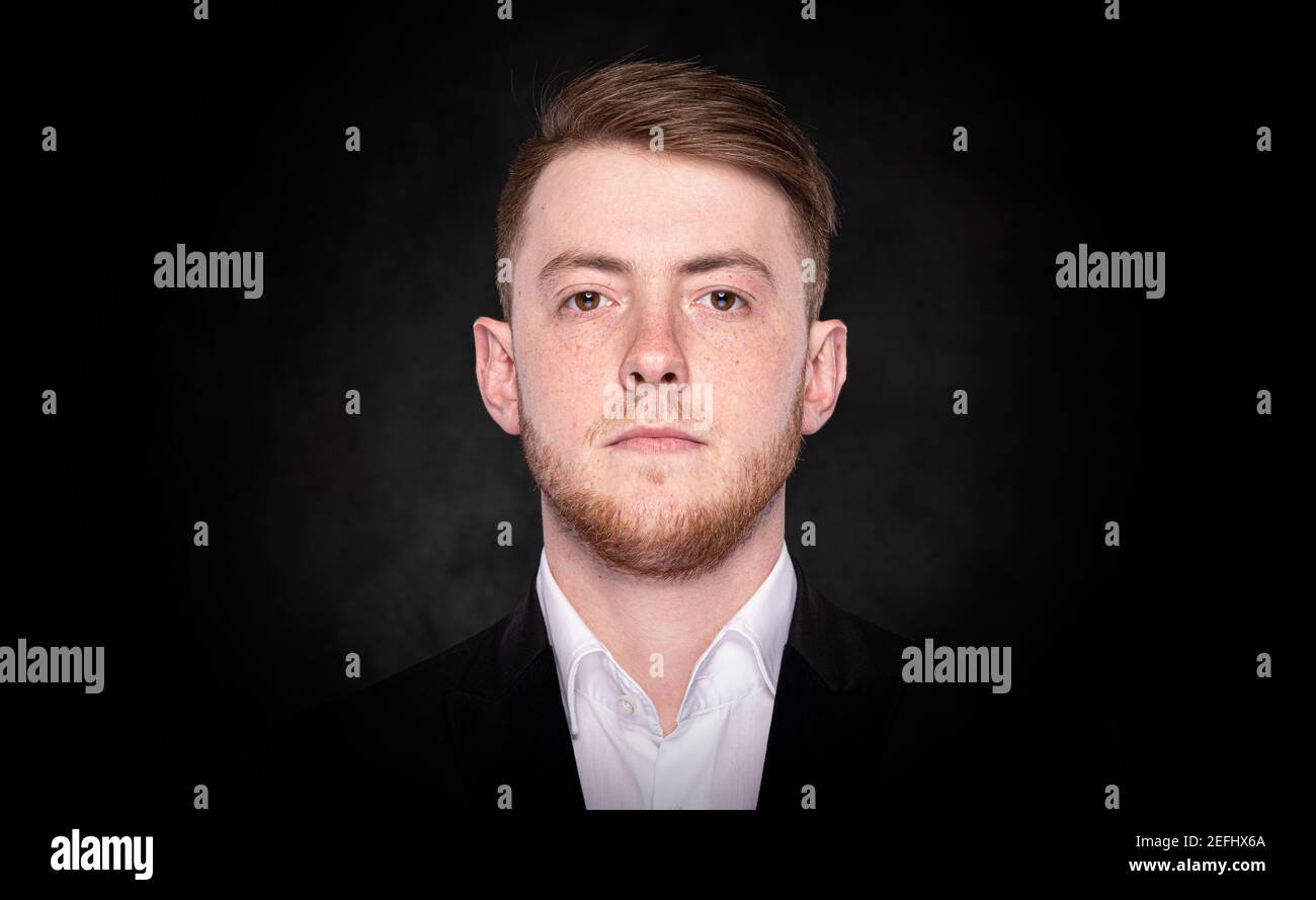 Intelligent man in a suit on a dark background Stock Photo - Alamy