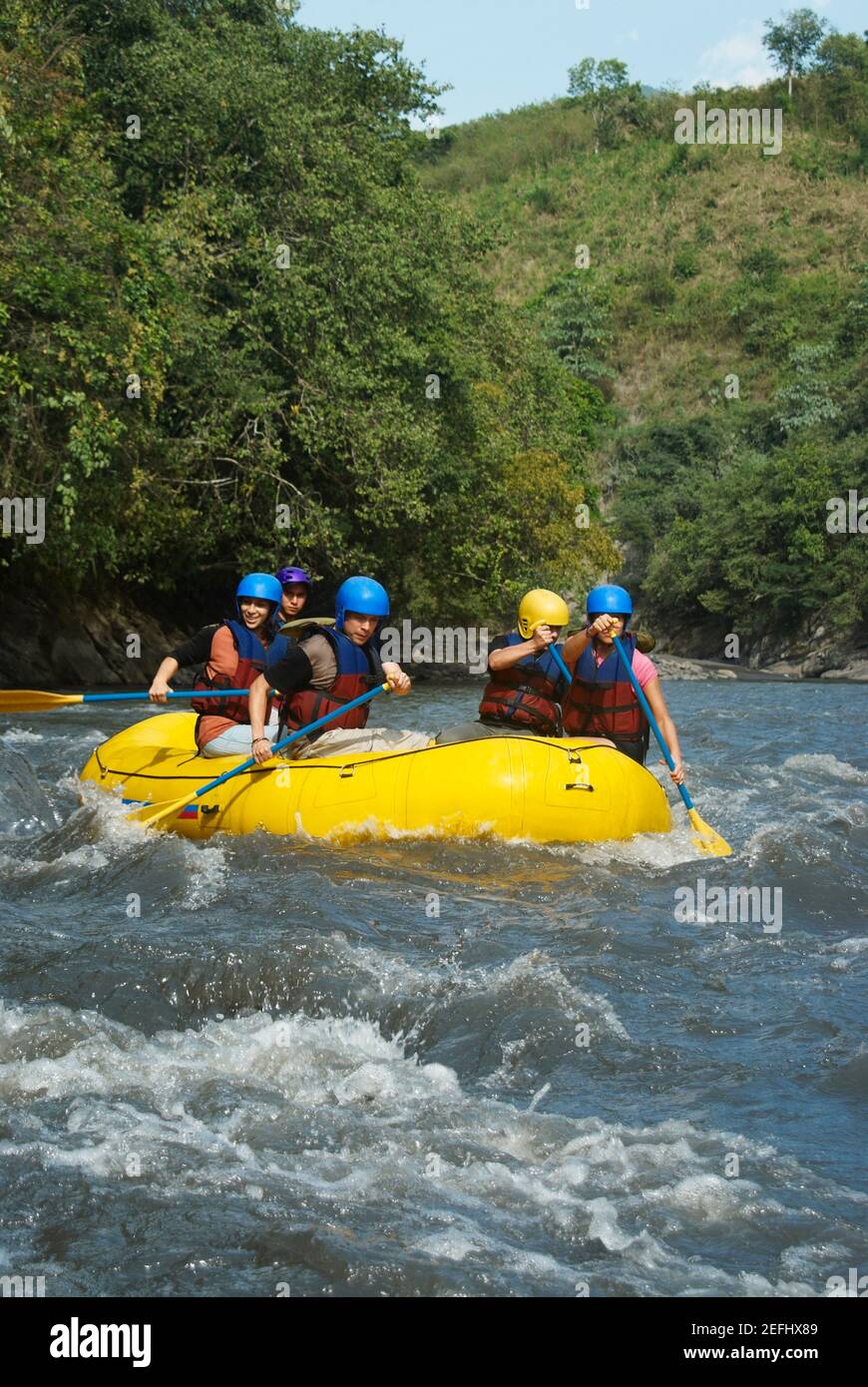 Five people rafting in a river Stock Photo - Alamy