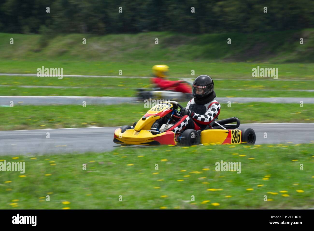 Person go-carting on a motor racing track Stock Photo - Alamy