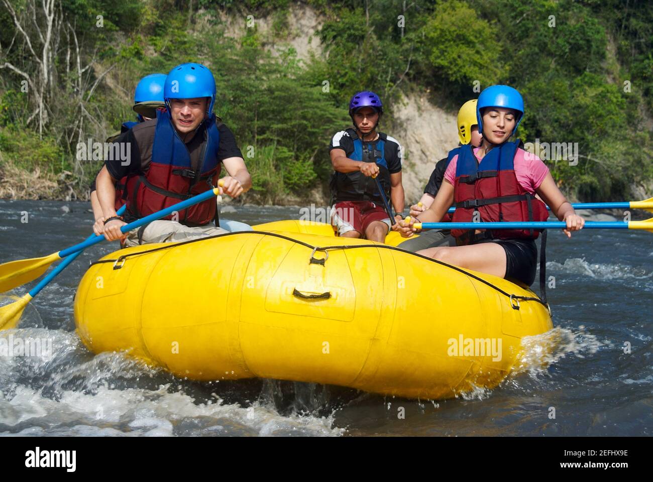 Five people rafting in a river Stock Photo - Alamy