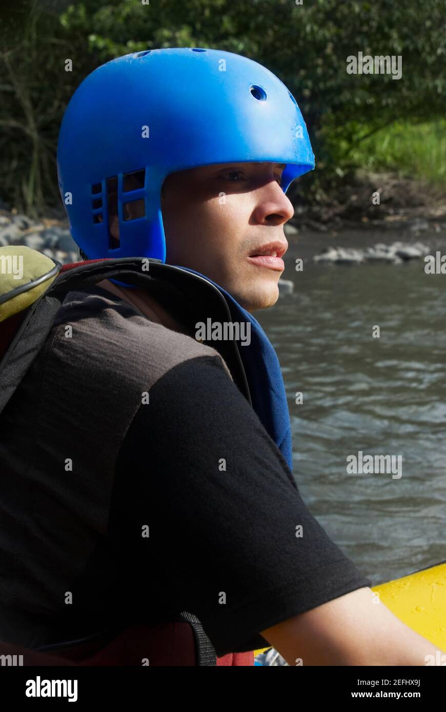 Side profile of a young man rafting in a river Stock Photo - Alamy
