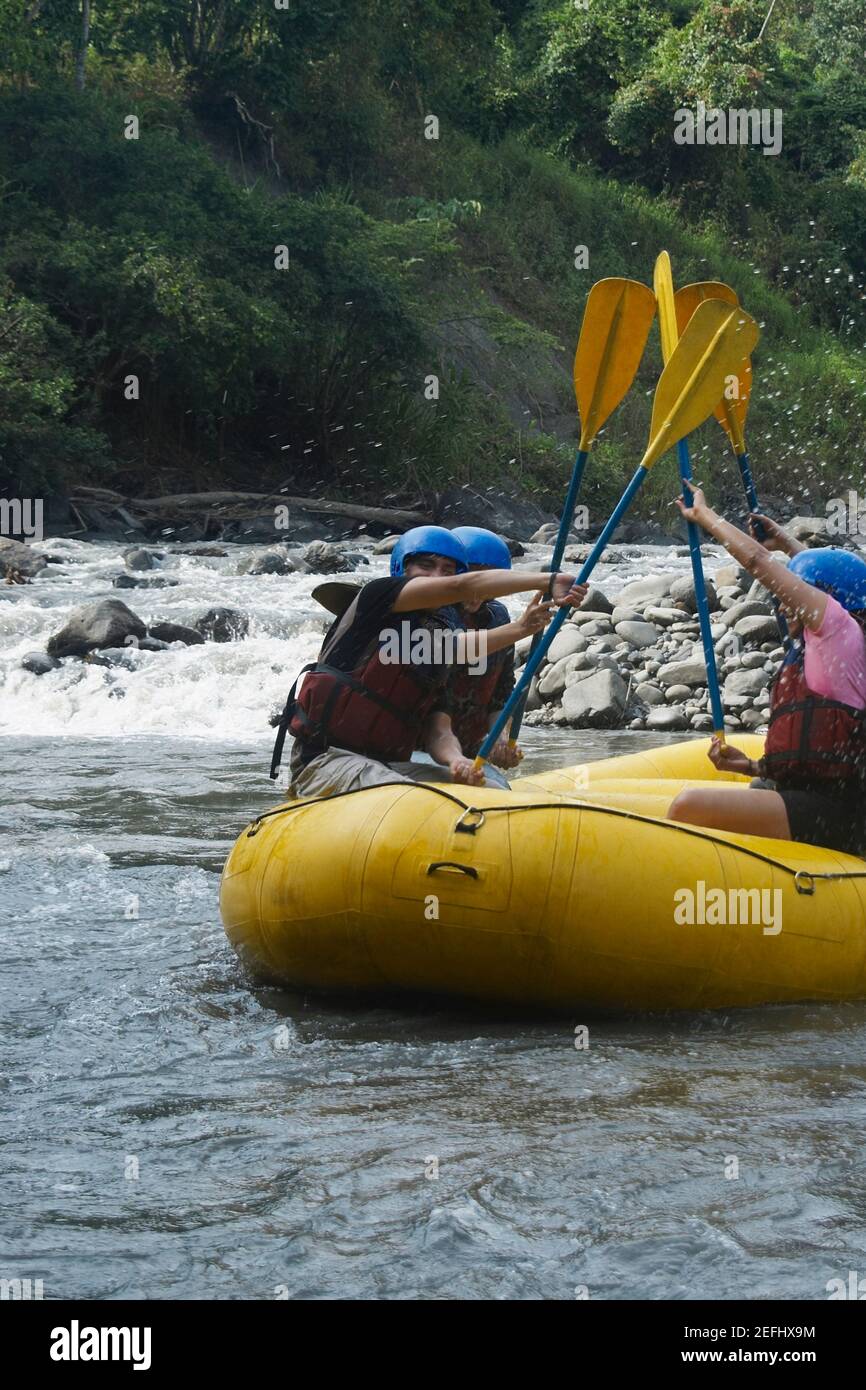 Side profile of four people rafting in a river Stock Photo - Alamy