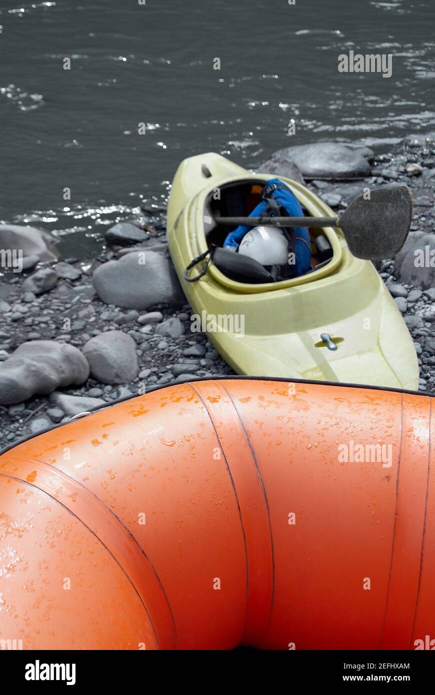 Close-up of an inflatable raft and a kayak at a riverbank Stock Photo ...
