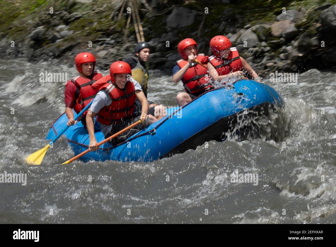 Five people rafting in a river Stock Photo - Alamy
