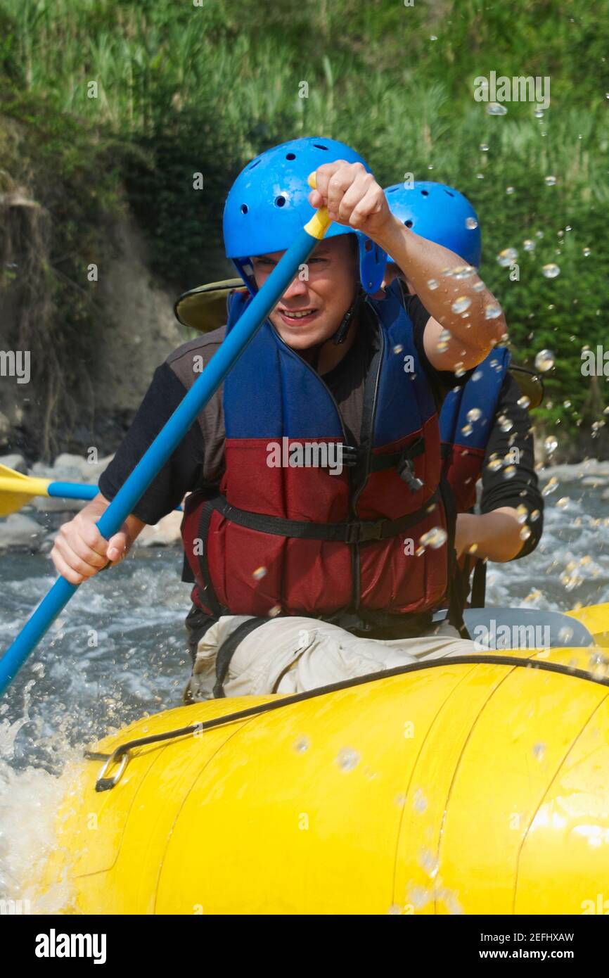 Two people rafting in a river Stock Photo - Alamy