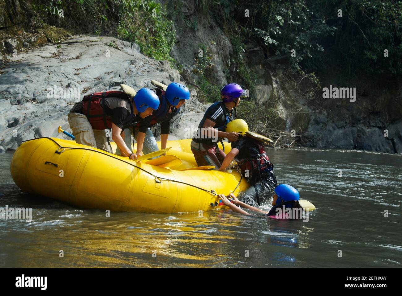 Side profile of three people pulling their friends on the raft Stock ...
