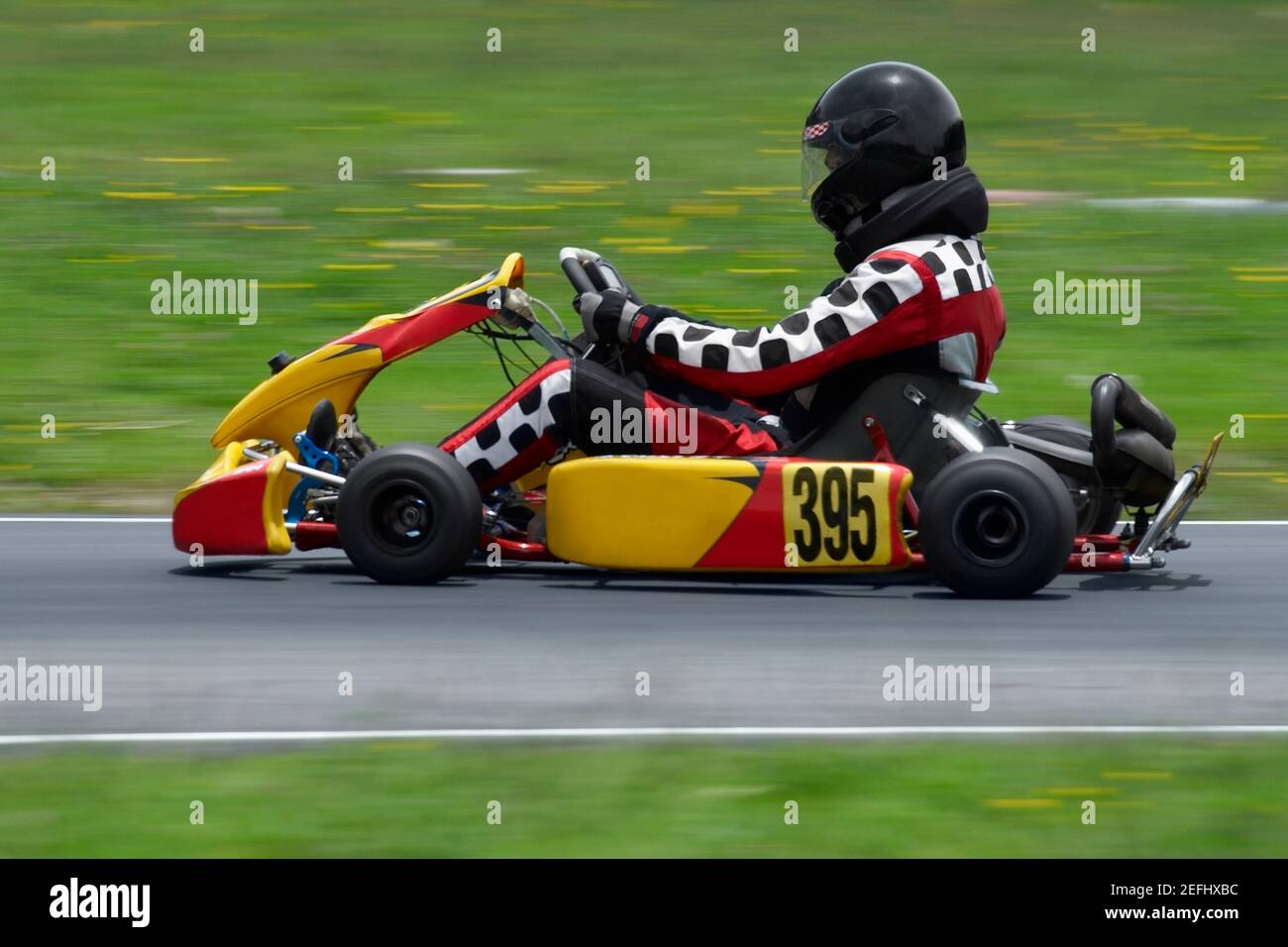 Side profile of a person go-carting on a motor racing track Stock Photo ...