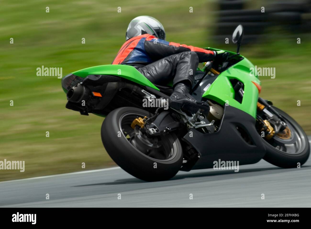Person riding a motorcycle on a motor racing track Stock Photo - Alamy