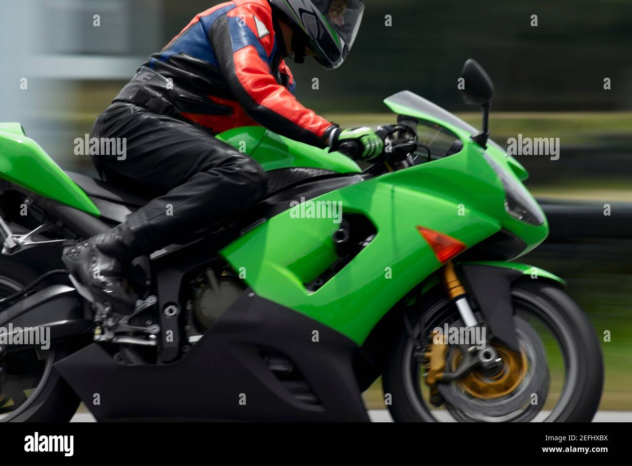 Side profile of a person riding a motorcycle Stock Photo - Alamy