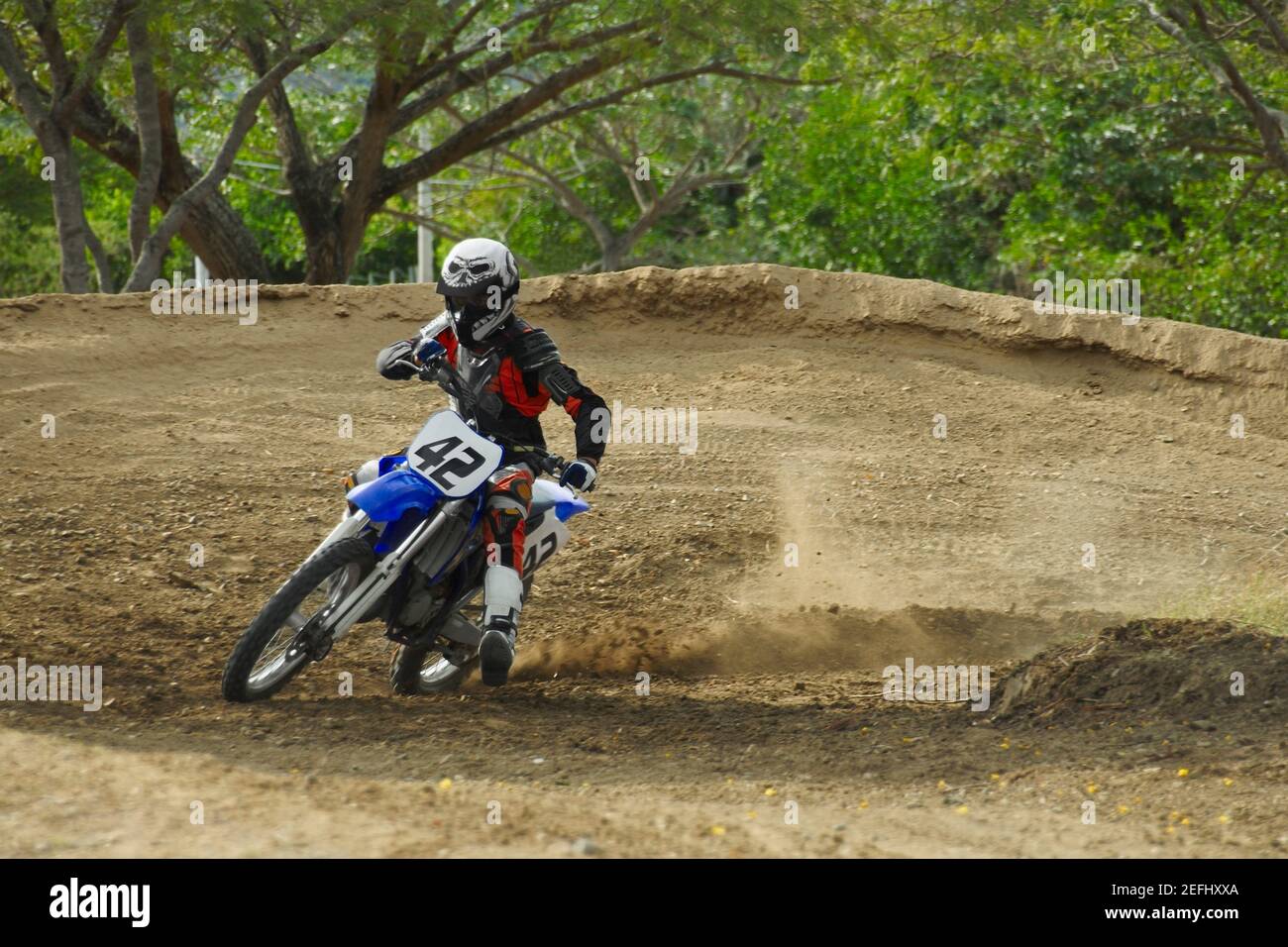 Motocross rider leaning into a turn Stock Photo - Alamy