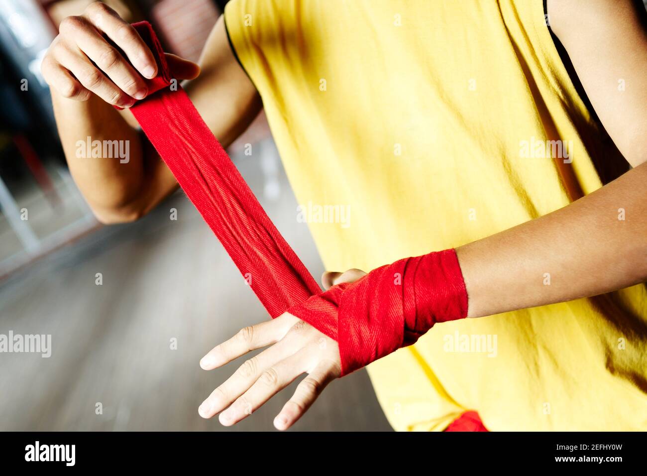 Mid section view of a male boxer wrapping his hand with a bandage Stock ...