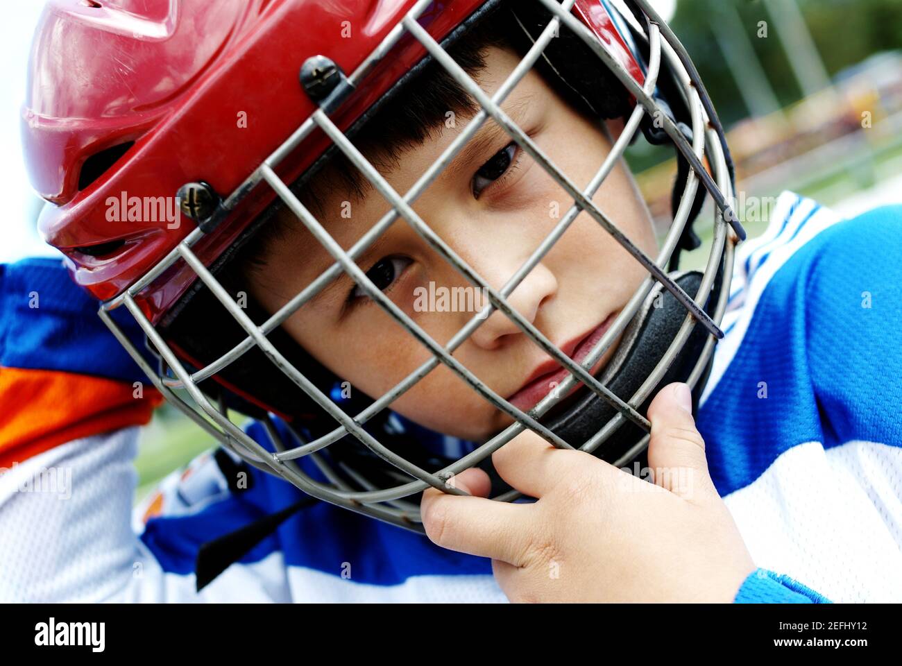 Portrait of a boy wearing an ice hockey helmet Stock Photo - Alamy