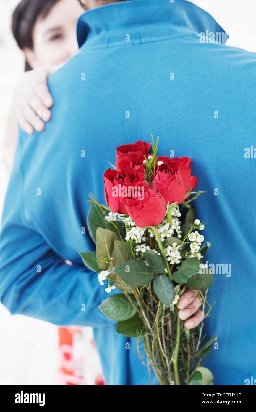 Man hiding rose behind back hi-res stock photography and images - Alamy
