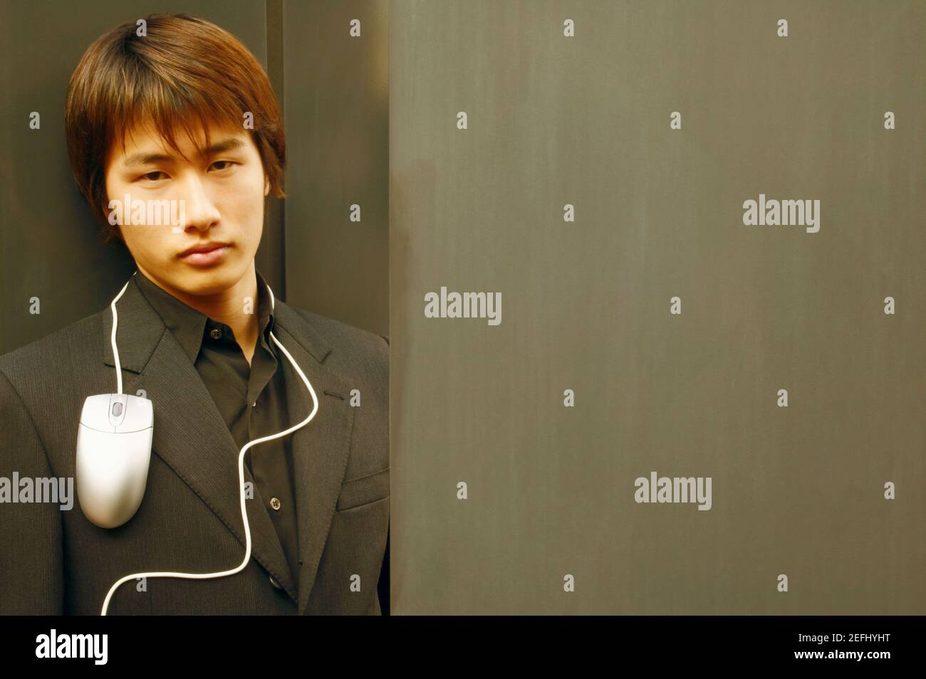 Portrait of a young man with a computer mouse around his neck Stock ...