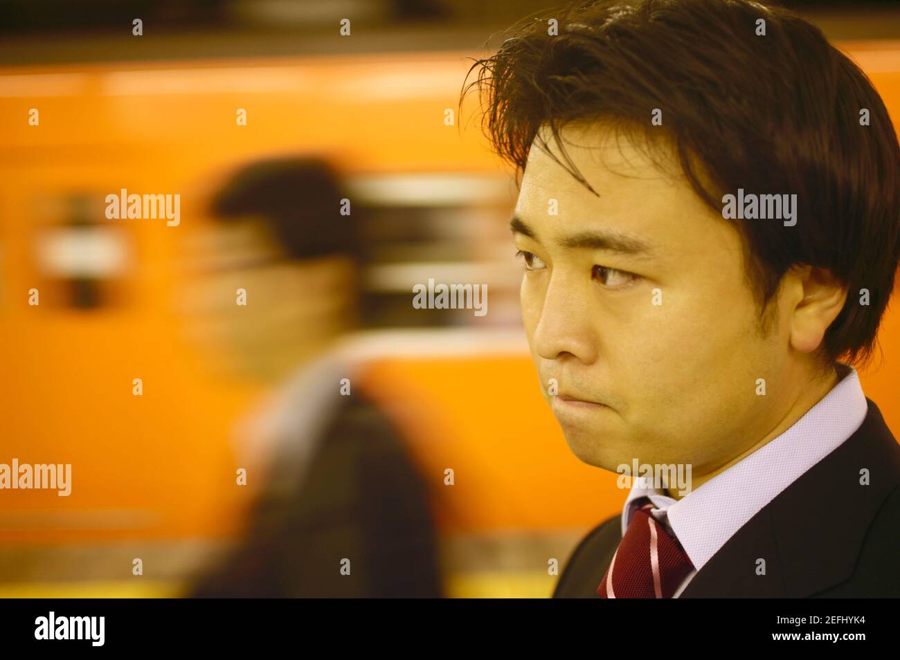 Side profile of a businessman biting his lip Stock Photo - Alamy