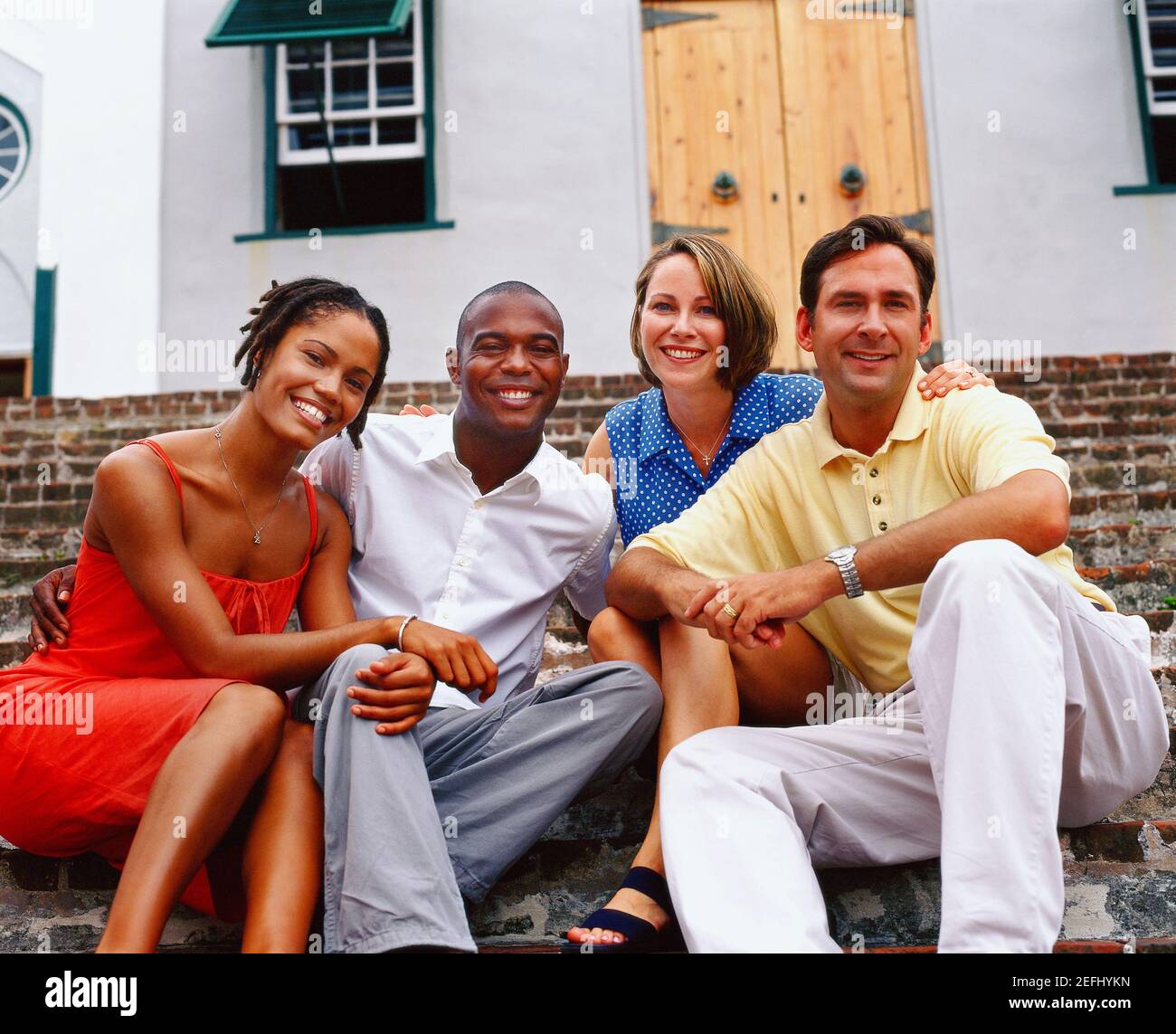 Portrait of two young couples sitting on steps and smiling, Bermuda ...