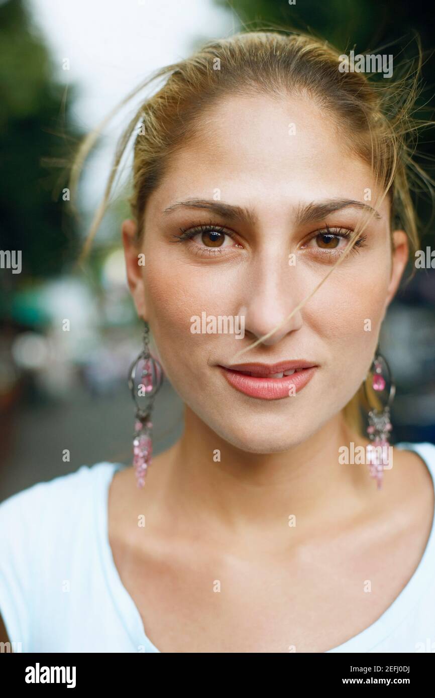 Portrait of a young woman smirking Stock Photo - Alamy