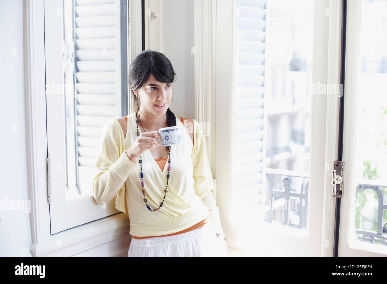Woman leaning against glass window hi-res stock photography and images ...