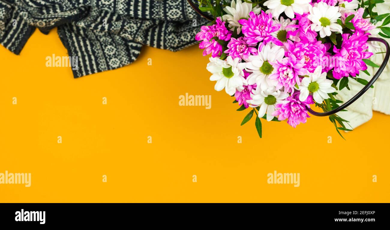 Spring workspace with bouquet of flowers and warm cozy clothes, sweater ...